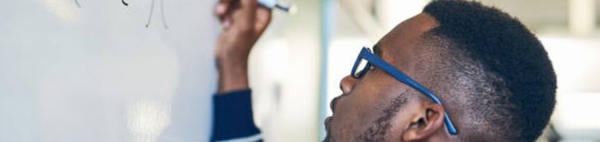 Unsplash- Student writing on board | Department of Mathematics